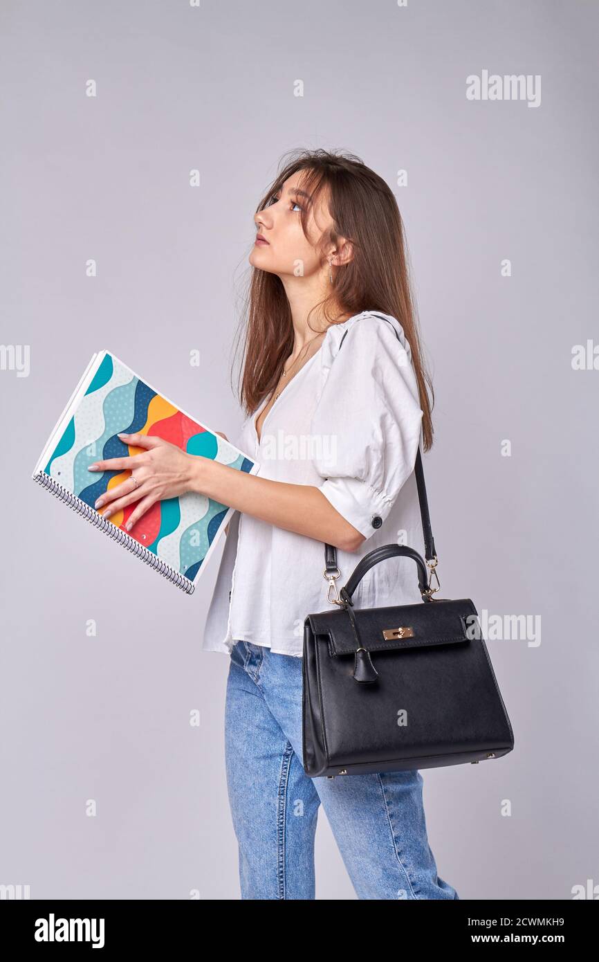 Serious student girl with closed book Stock Photo - Alamy