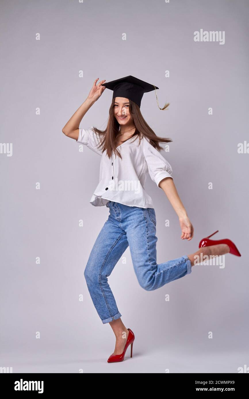 Excited graduate girl is jumping Stock Photo - Alamy