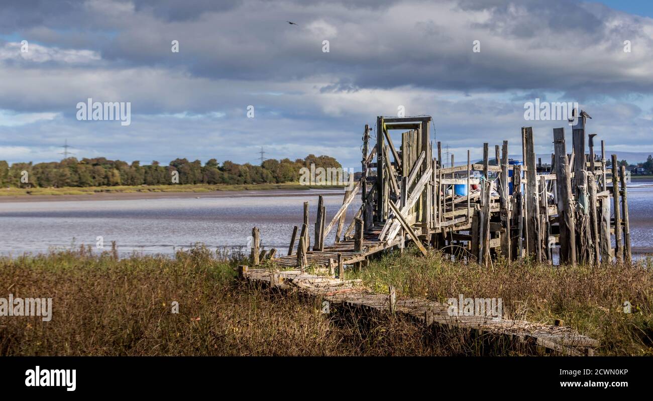 View of river with old jetty Stock Photo - Alamy