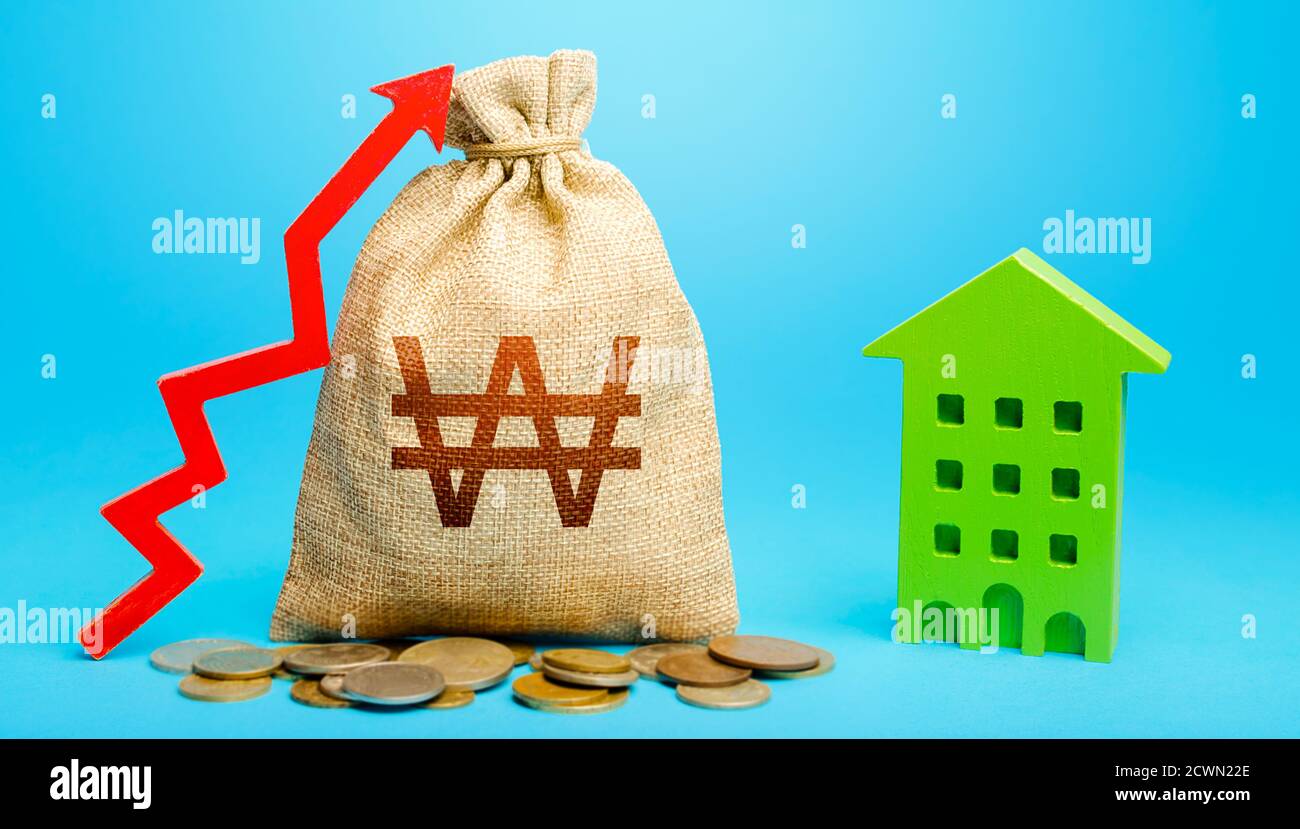 South korean won money bag with red up arrow and residential building ...
