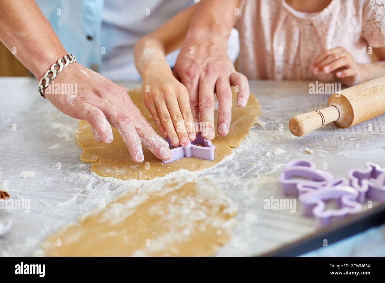 Father and daughter make cookies by mold, together in kitchen, Family ...