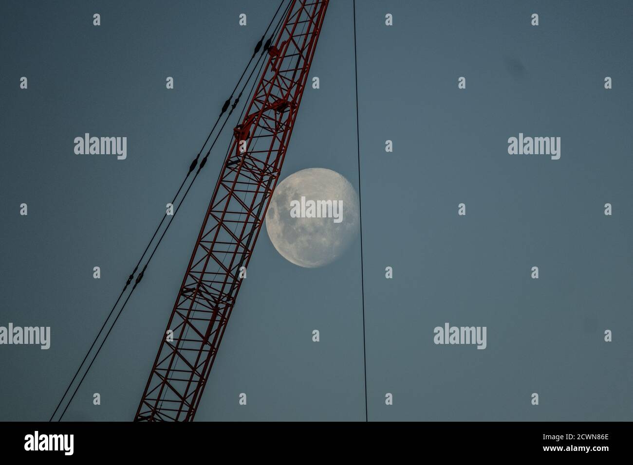 Construction : The Moon rises behind a crane in Melbourne Australia ...