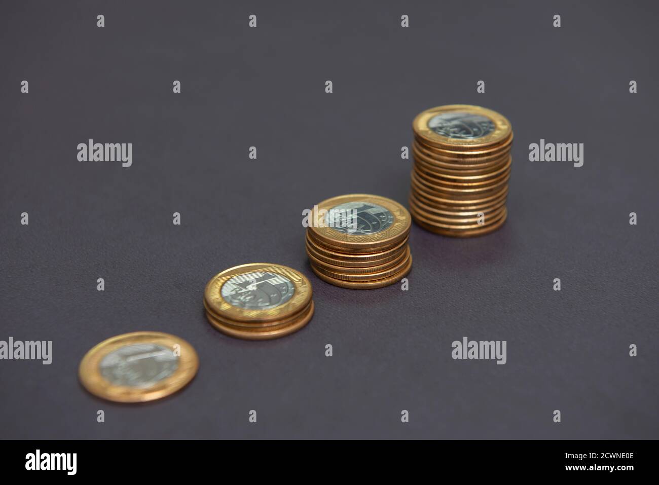 Stacks of golden and silver coins (1 Real) as in a growing graph ...
