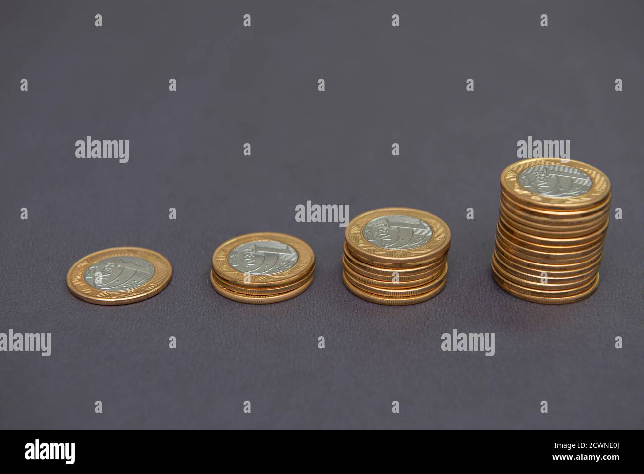Stacks of golden and silver coins (1 Real) as in a growing graph ...