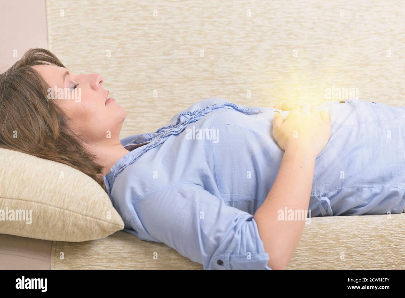 Woman practicing self Reiki transfering energy through palms, a kind of ...