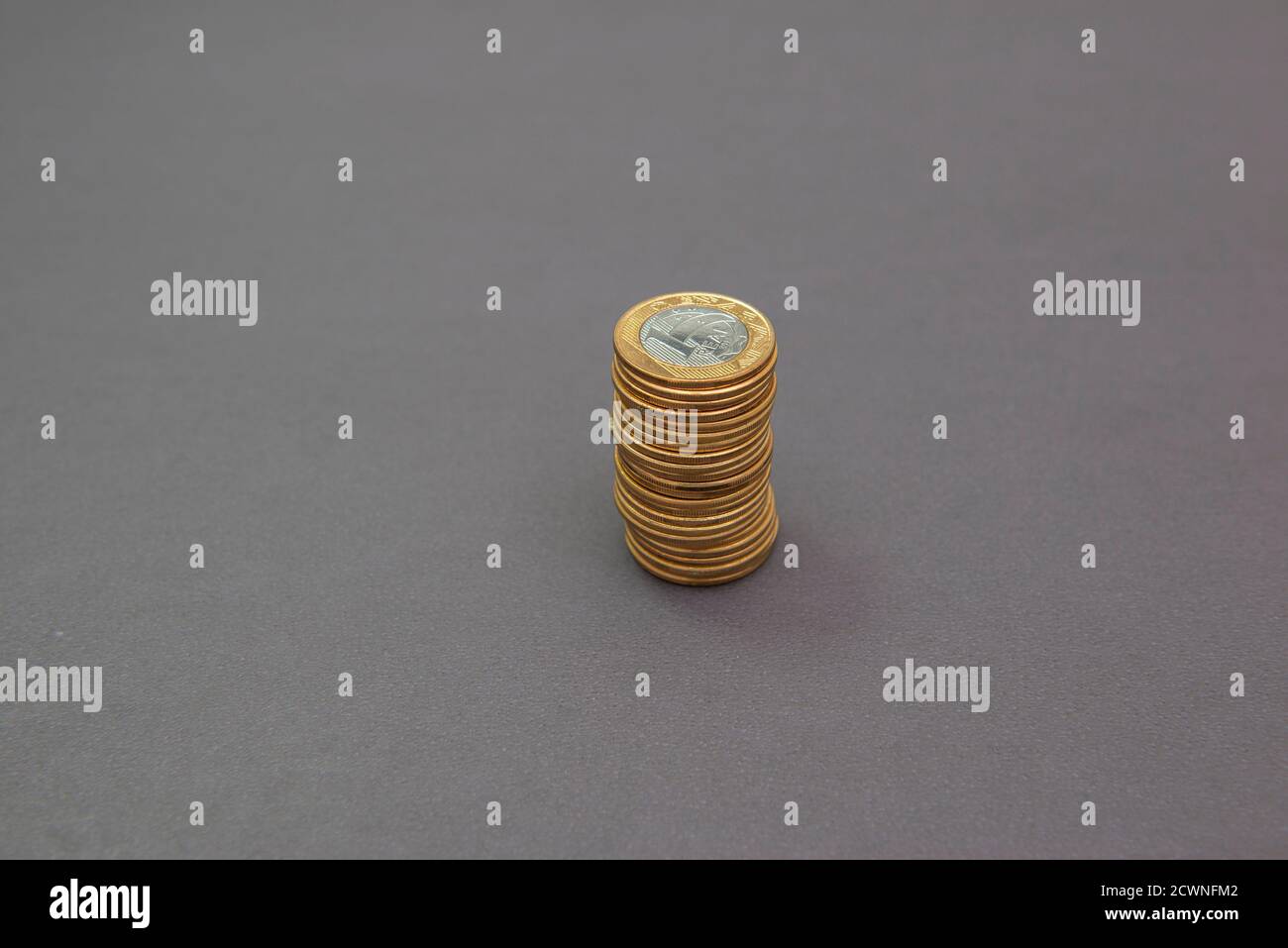 Stack of 1 real coins isolated on black background. Concept of saving ...