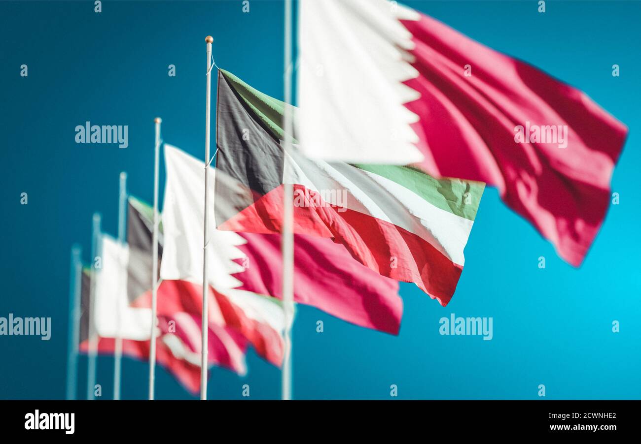 Quatar and Kuwait flags waving against blue sky background. Kuwait and ...