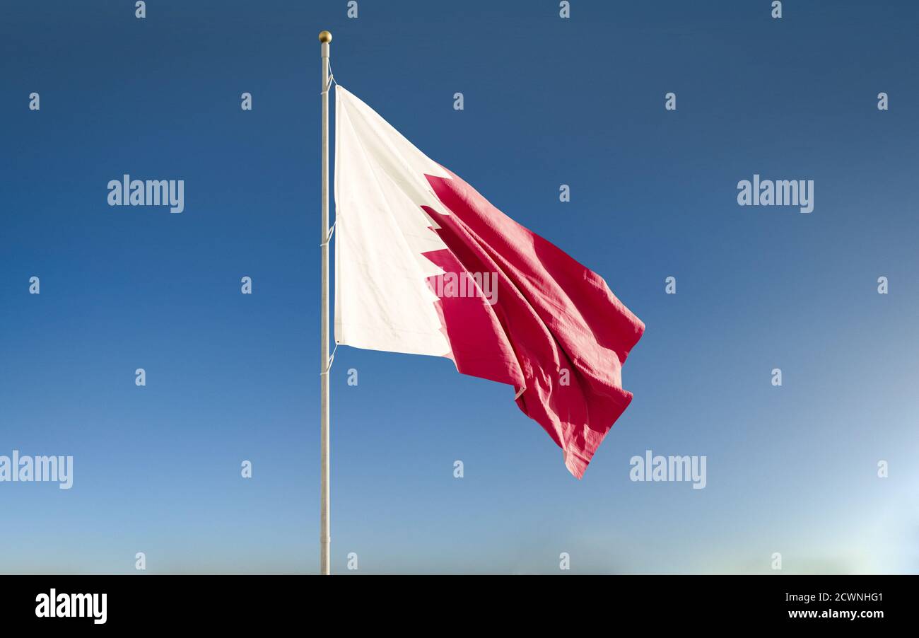 Quatar national flag waving against blue sky background. Isolated Stock ...
