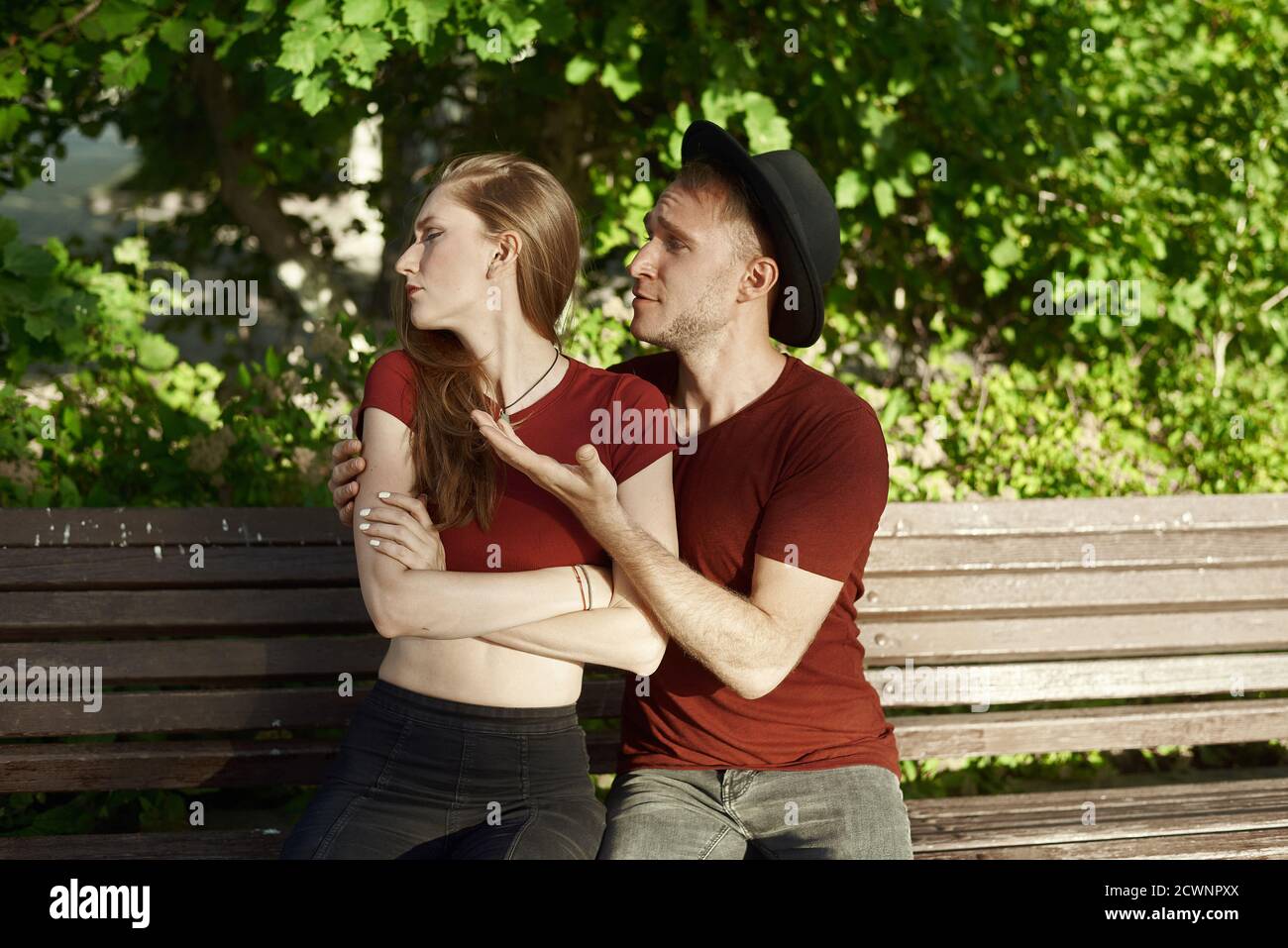 A couple is breaking up. The boy and girl is siting back to each other ...