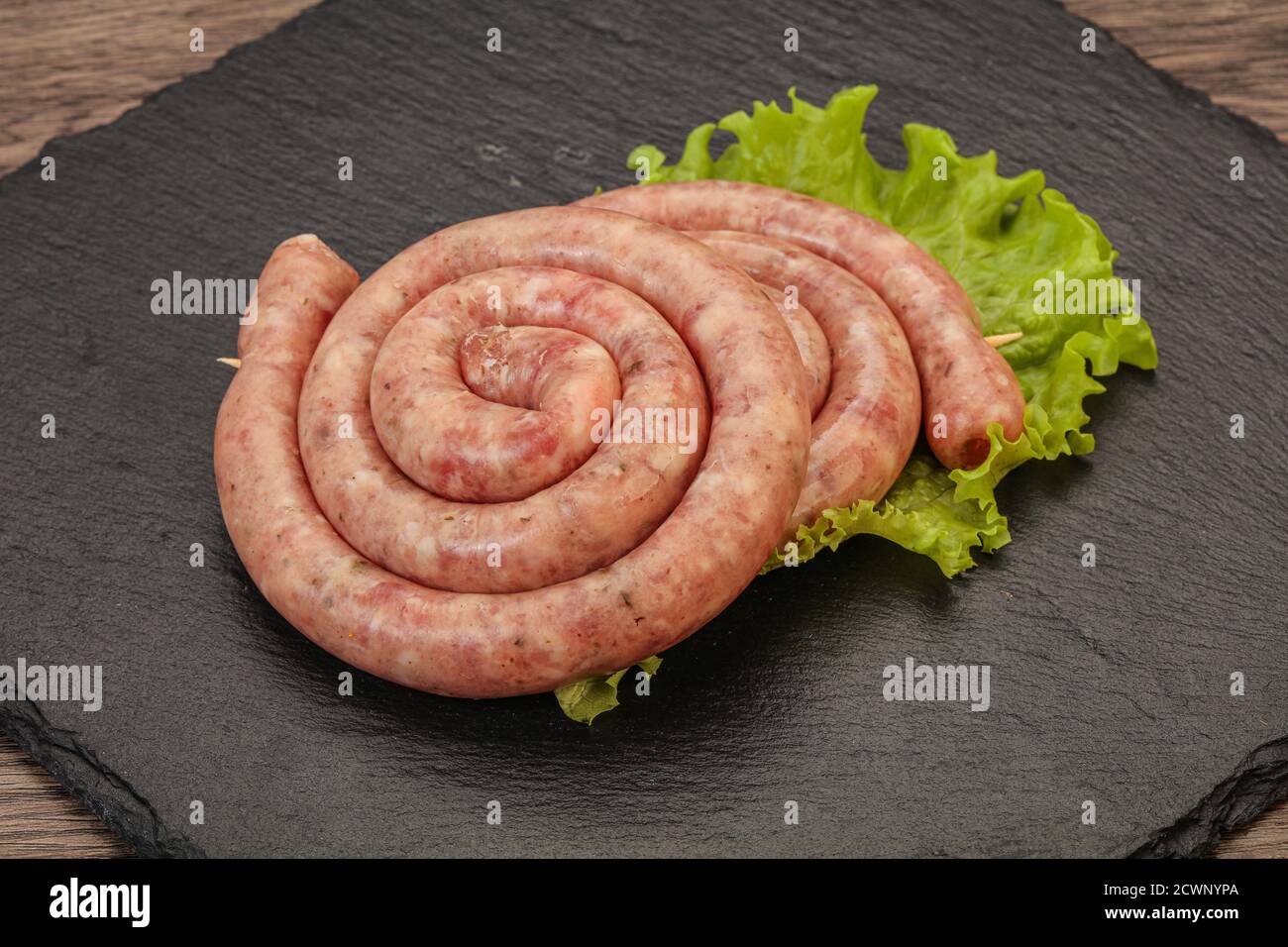 Raw pork sausage ring for grill Stock Photo - Alamy