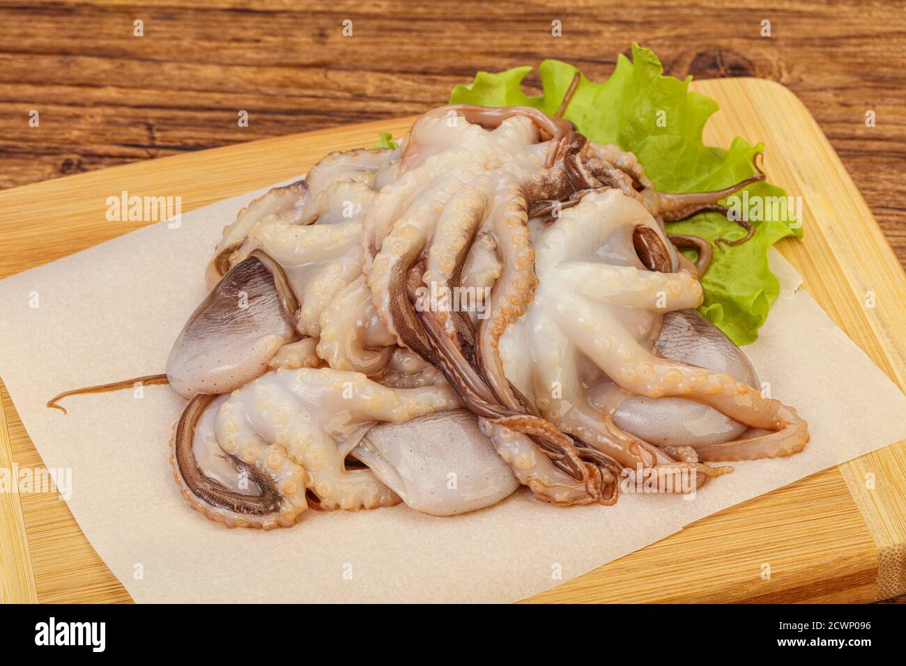 Raw seafood - octopus for cooking over the board Stock Photo - Alamy