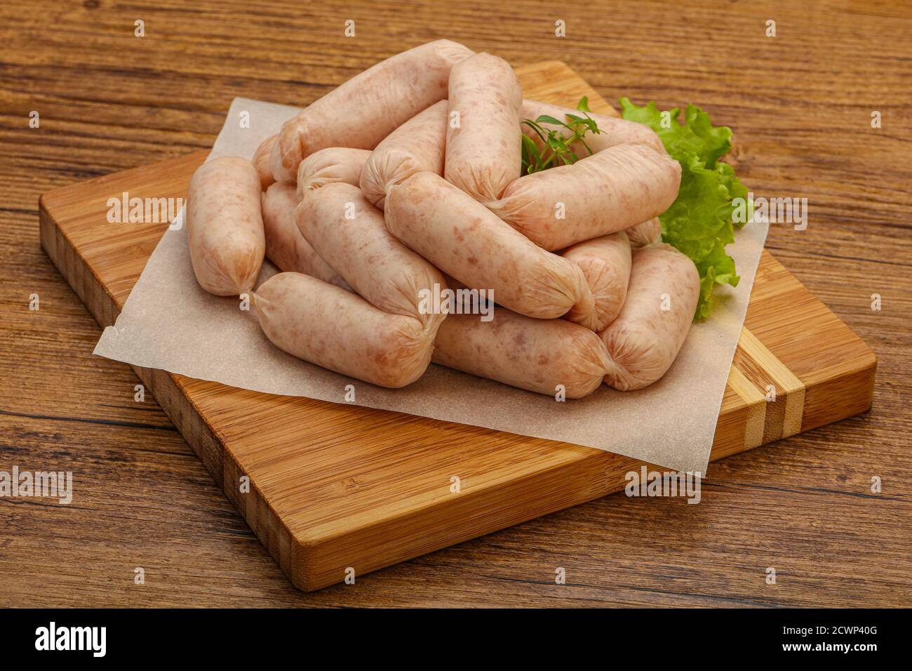 Raw natural chicken baby sausages for roast Stock Photo - Alamy