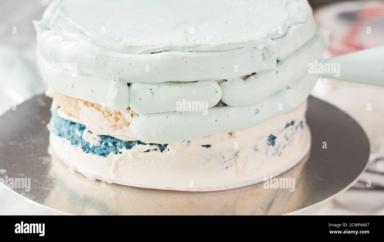 Frosting round three-layer vanilla cake with buttercream frosting Stock ...