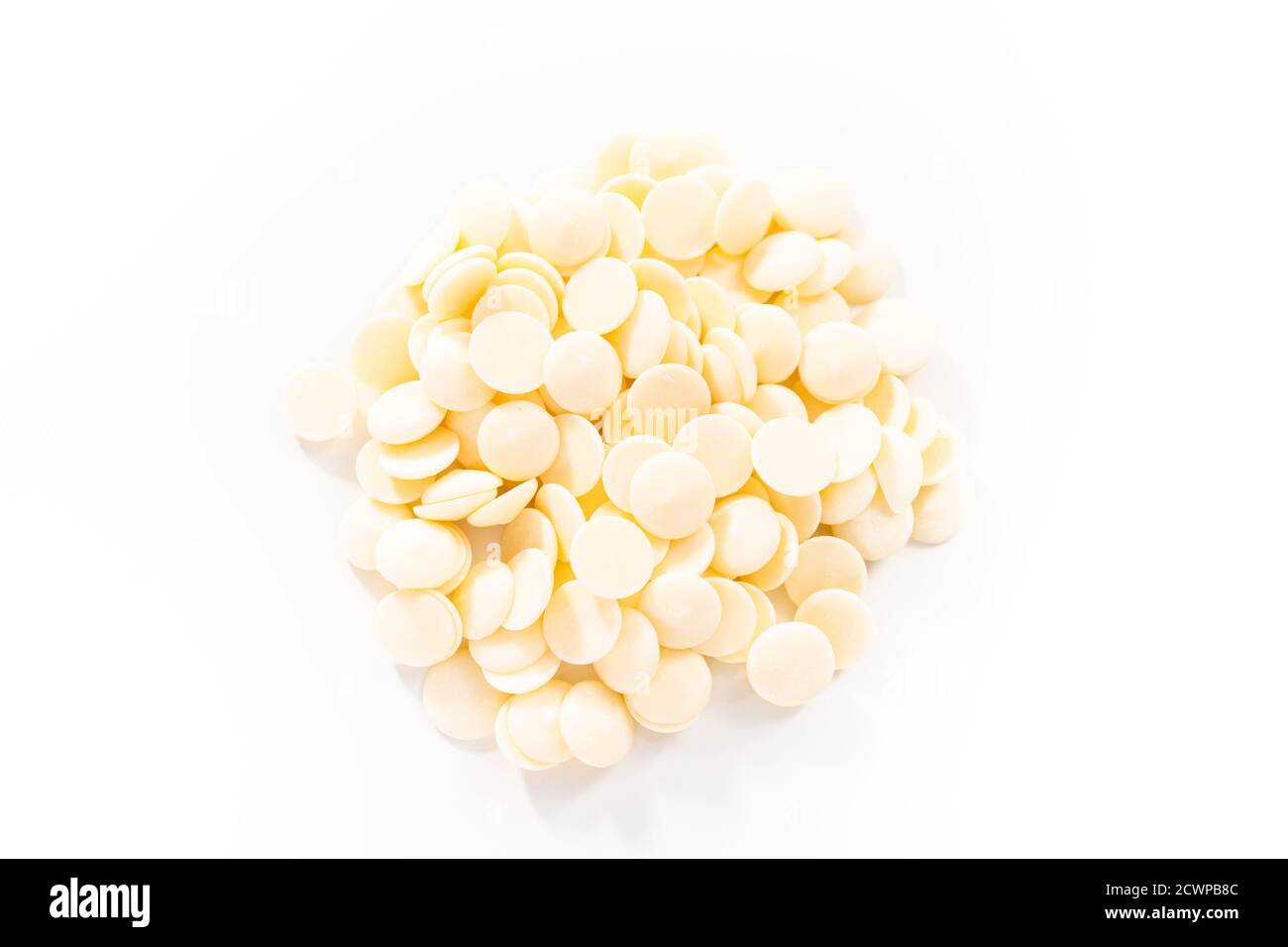 White round chocolate chips for melting chocolate shapes on a white ...