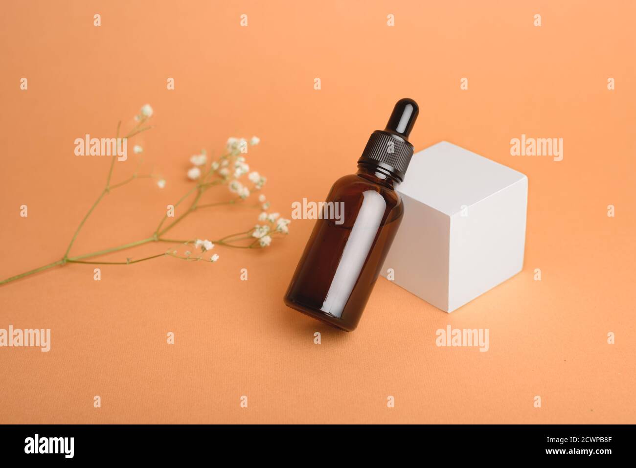 A glass bottle stands with aromatic oil on a cube Stock Photo - Alamy