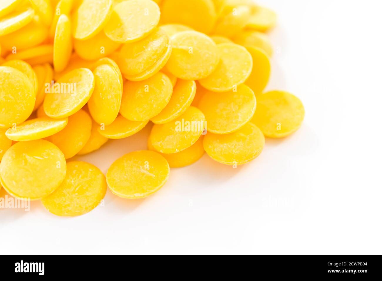 Yellow round chocolate chips for melting chocolate shapes Stock Photo ...