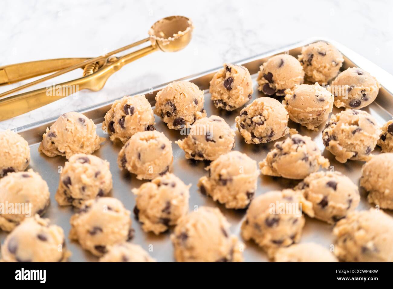 Homemade chocolate chip cookies dough scoops on a baking sheet Stock ...