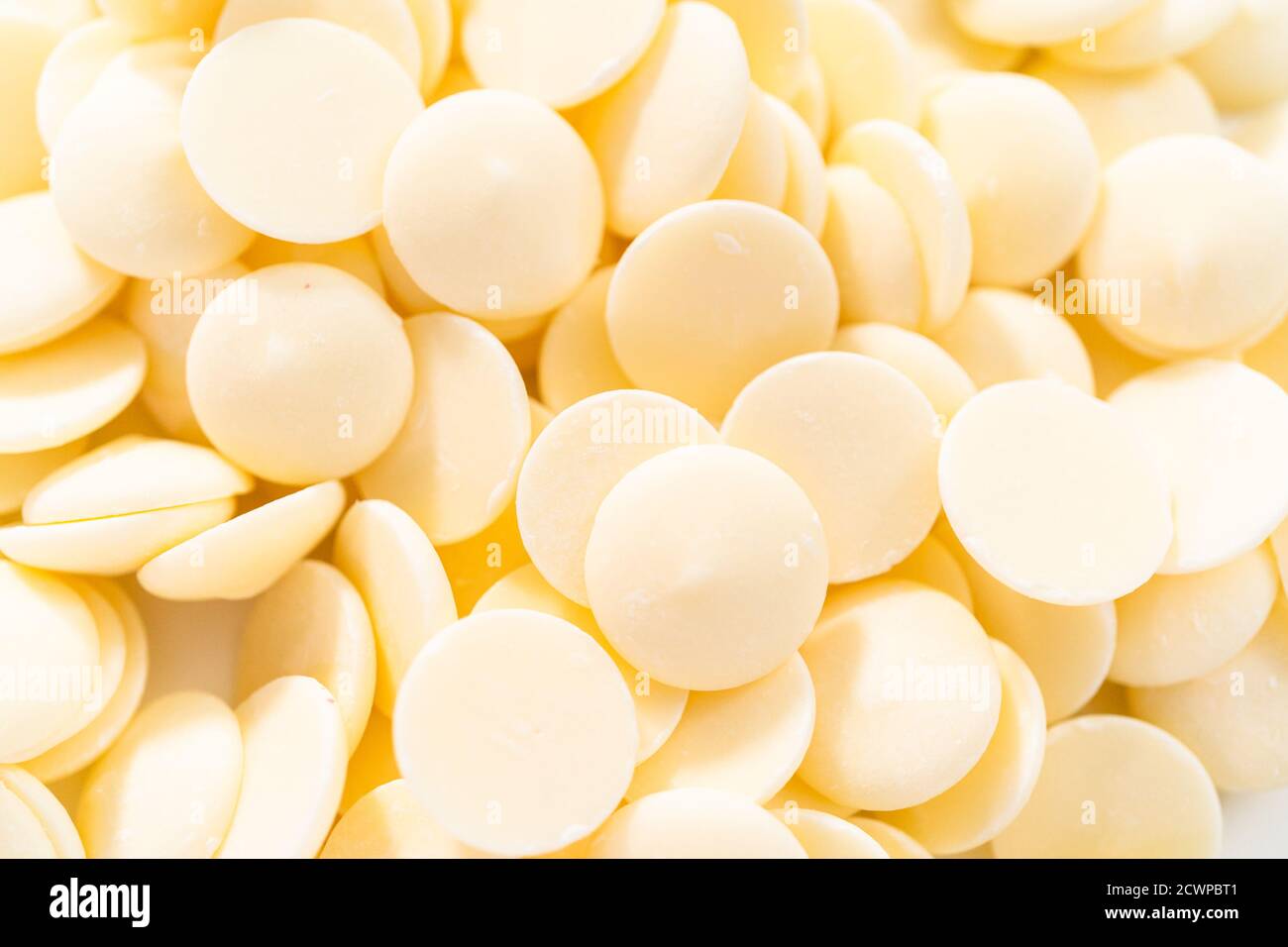 White round chocolate chips for melting chocolate shapes on a white ...