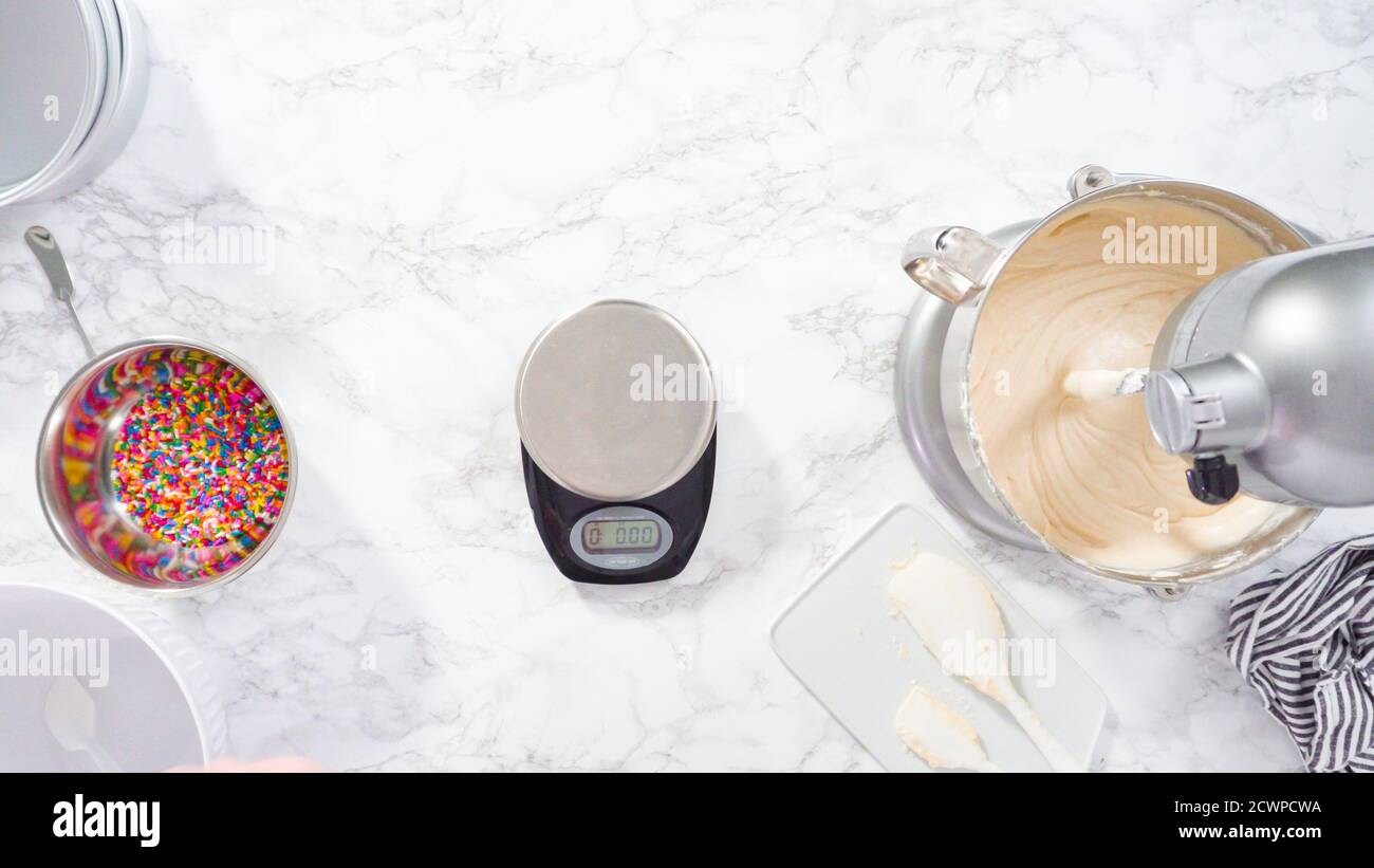 Flat lay. Step by step. Measuring funfetti cake batter on a digital ...
