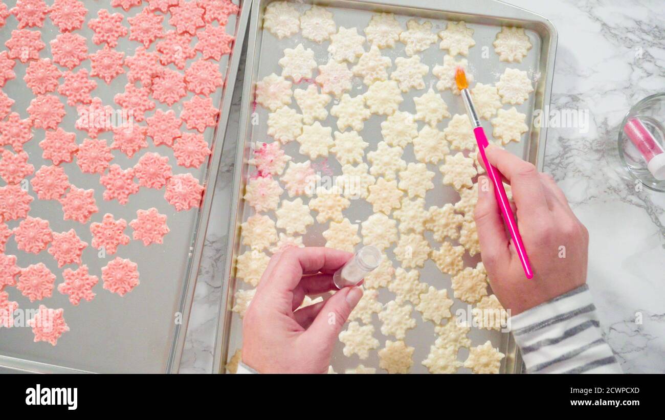 Flat lay. Step by step. Dusting chocolate snowflakes with glittery food ...