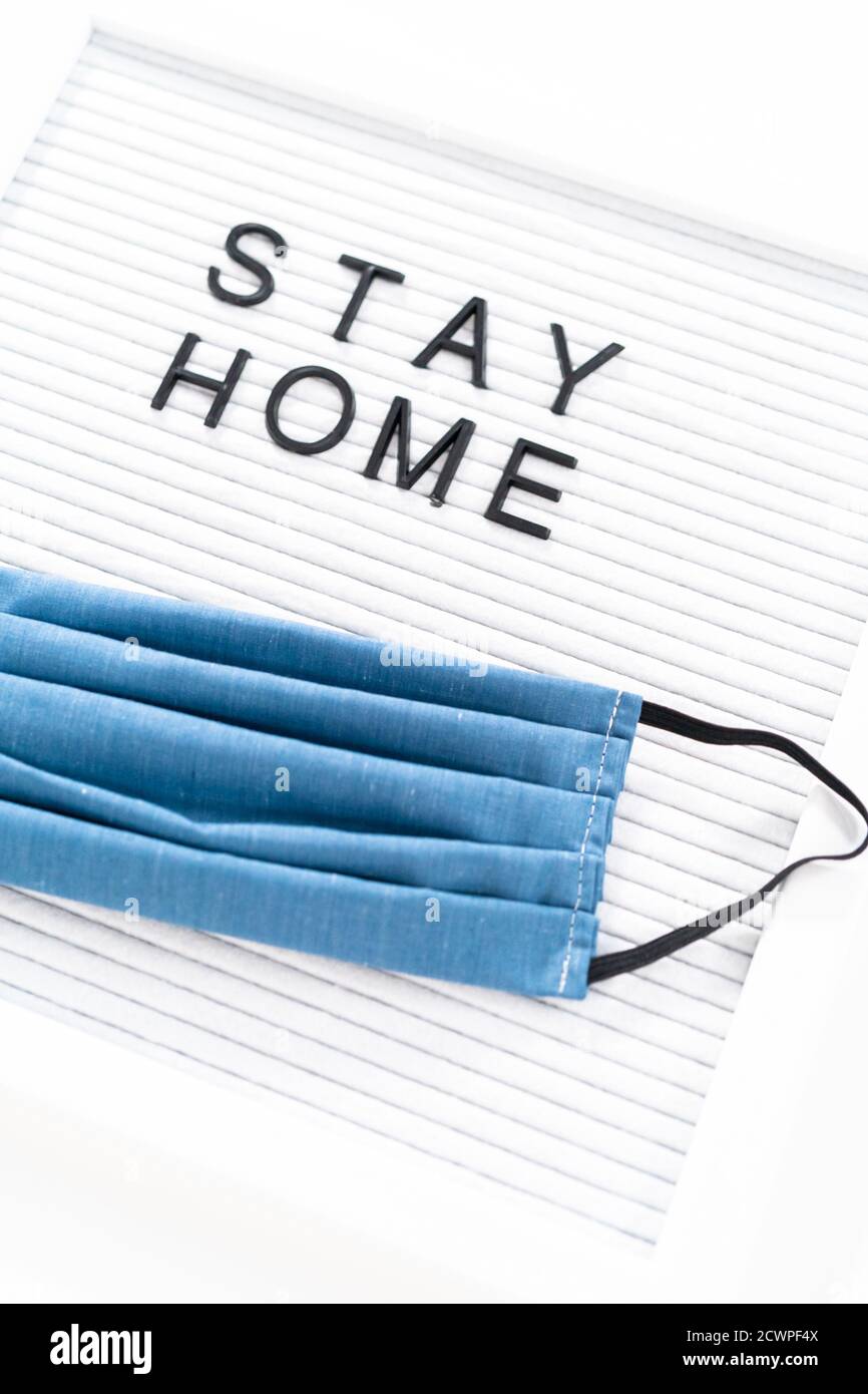 STAY HOME sign on message board with a homemade face mask Stock Photo ...