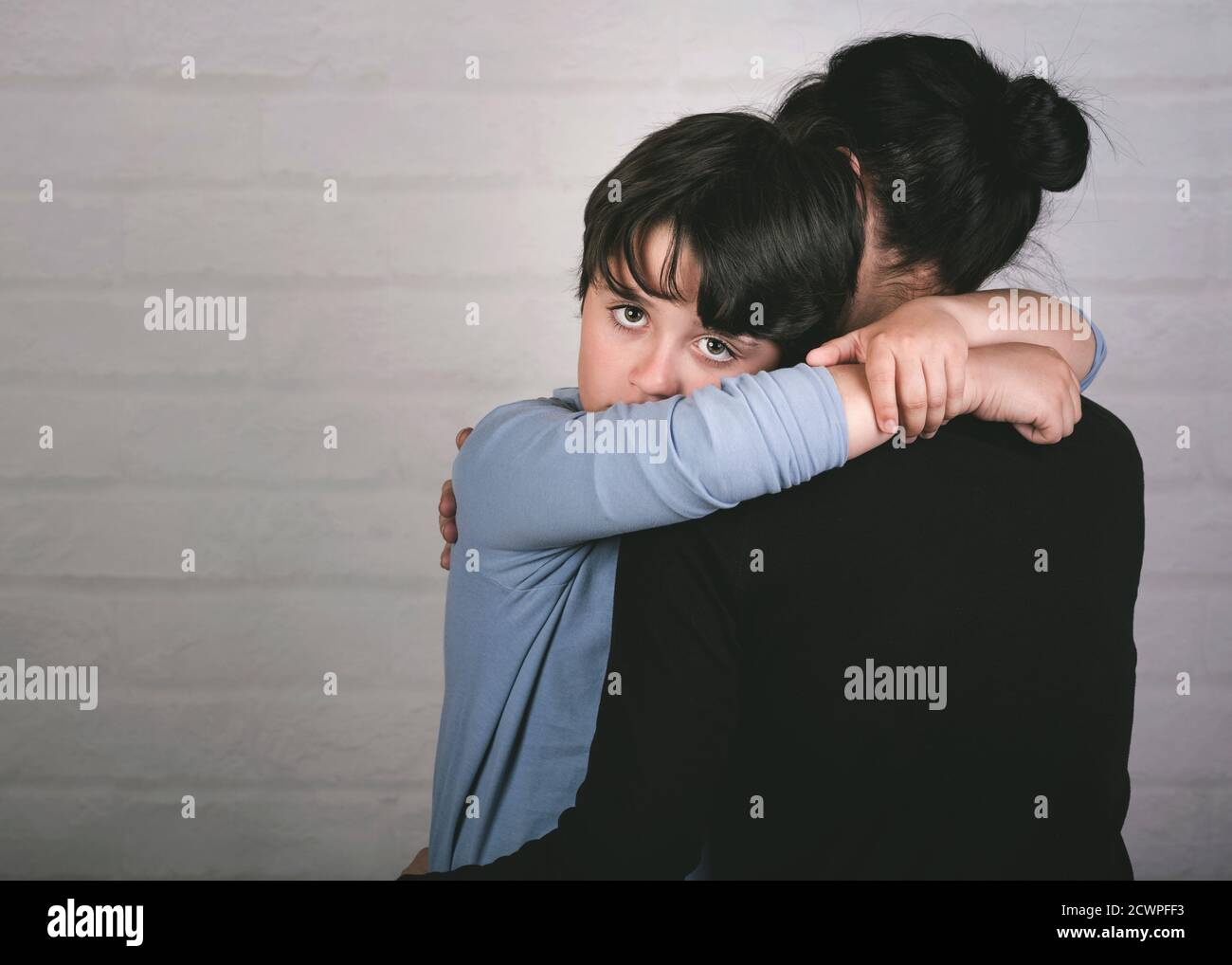 Mother hugging son sad hi-res stock photography and images - Alamy