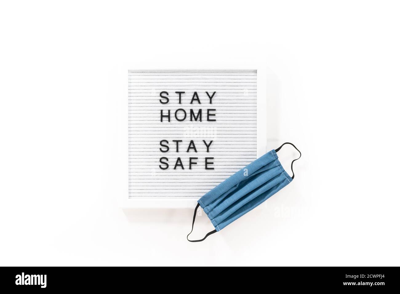 STAY HOME and STAY SAFE sign on message board with a homemade face mask ...