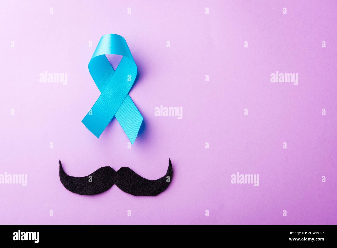Black mustache paper and light blue ribbon, studio shot isolated on ...