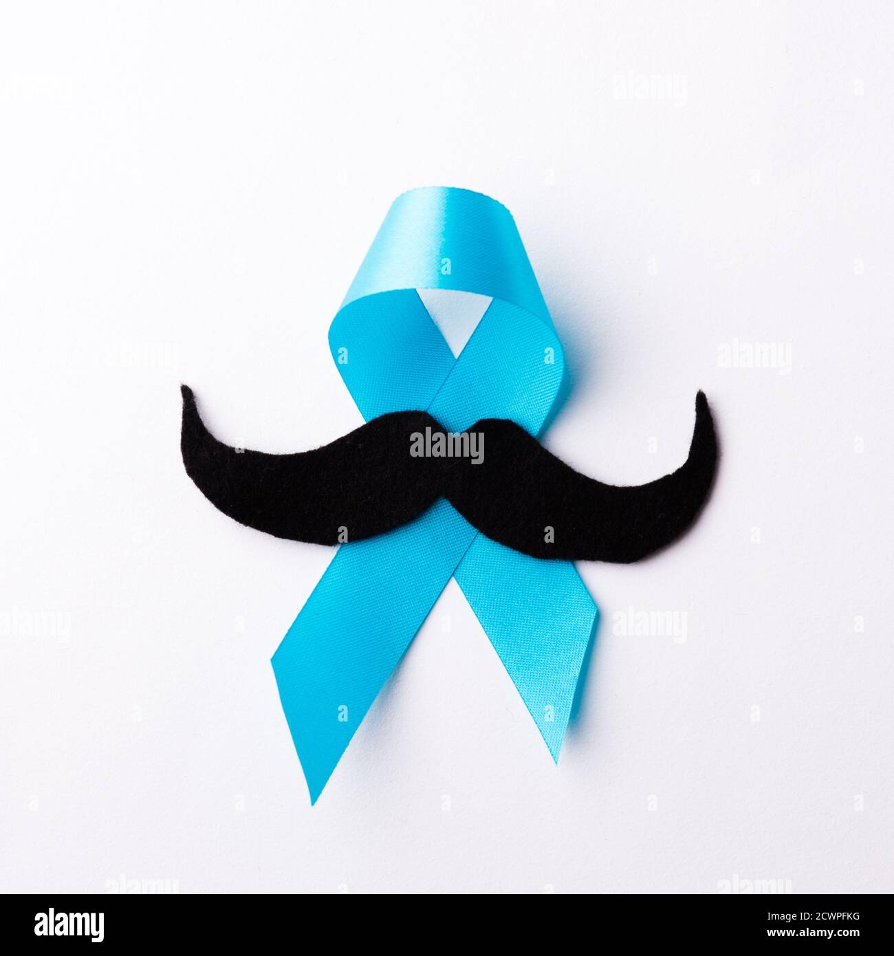 Black mustache paper and light blue ribbon, studio shot isolated on ...