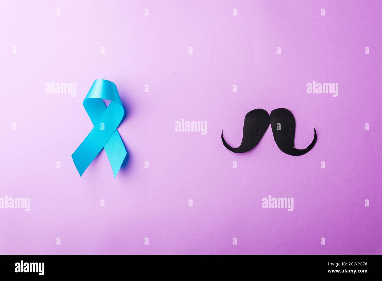 Black mustache paper and light blue ribbon, studio shot isolated on ...