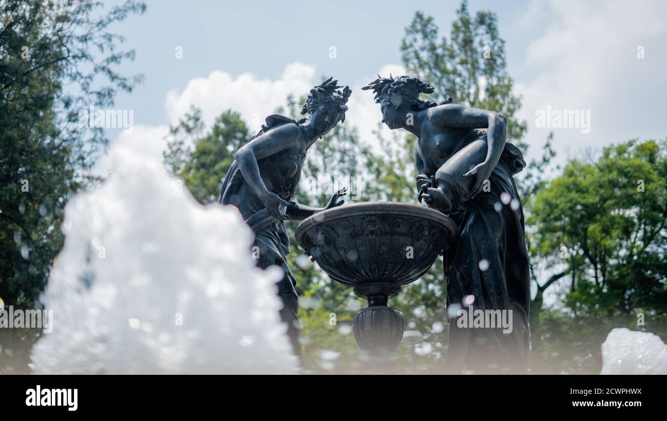 Bronze Statue of Two Women Pouring Down Water Into a Bird Waterer ...