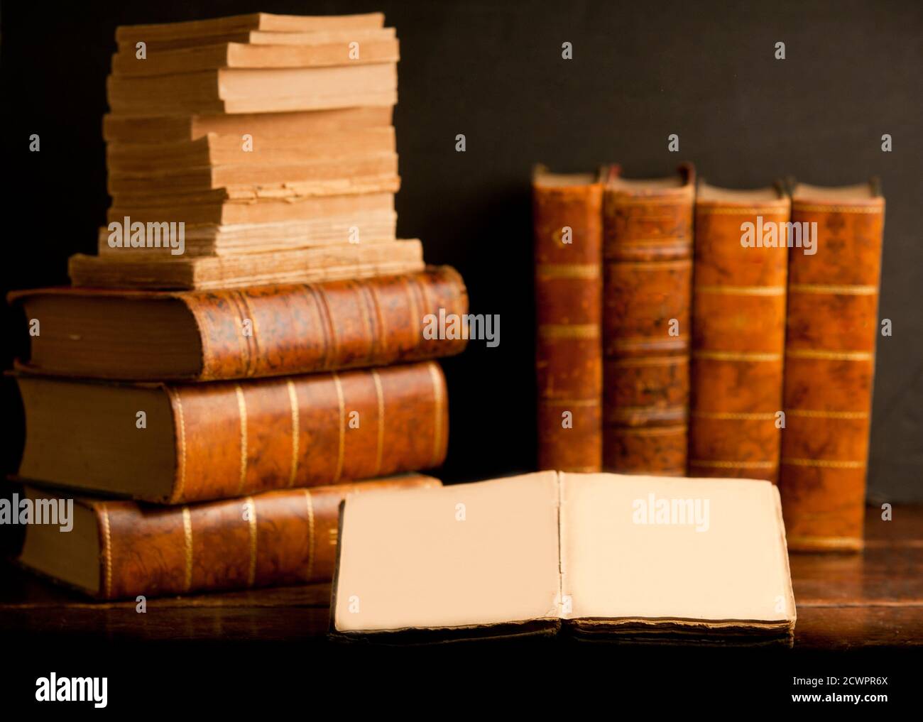 stack of old retro books on old wooden shelf and dark background Stock ...