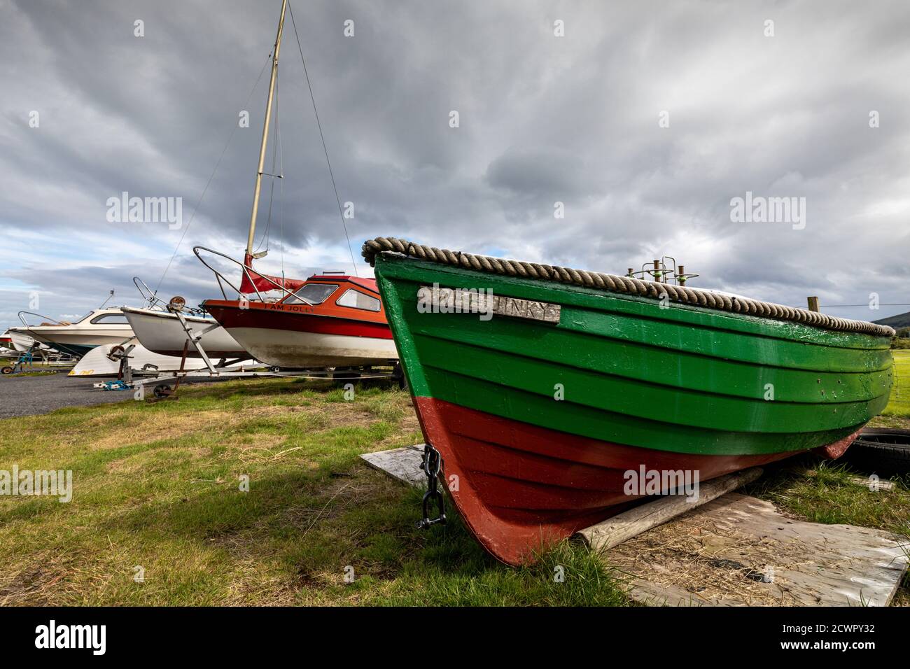 Colourful boats are stored at Sheep Harbour near Corrie, Isle of Arran ...