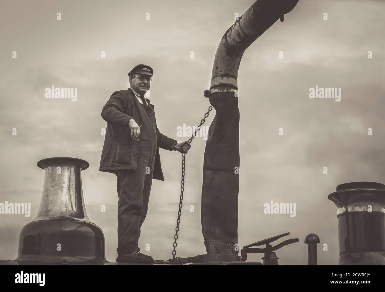 Mono steam train crew fireman filling vintage steam locomotive with ...