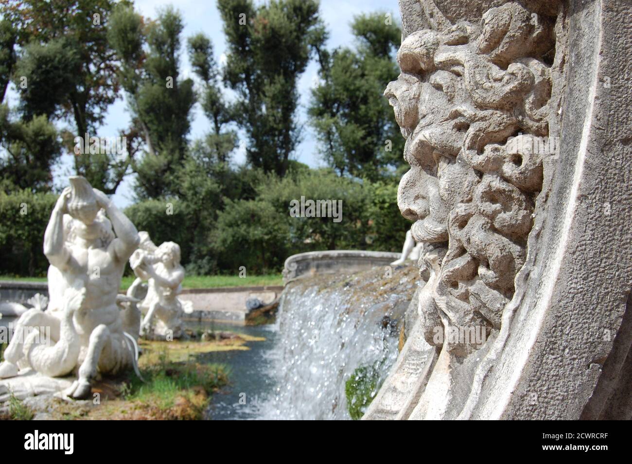 Statue detail of a human head figure in the park of Reggia of Caserta ...