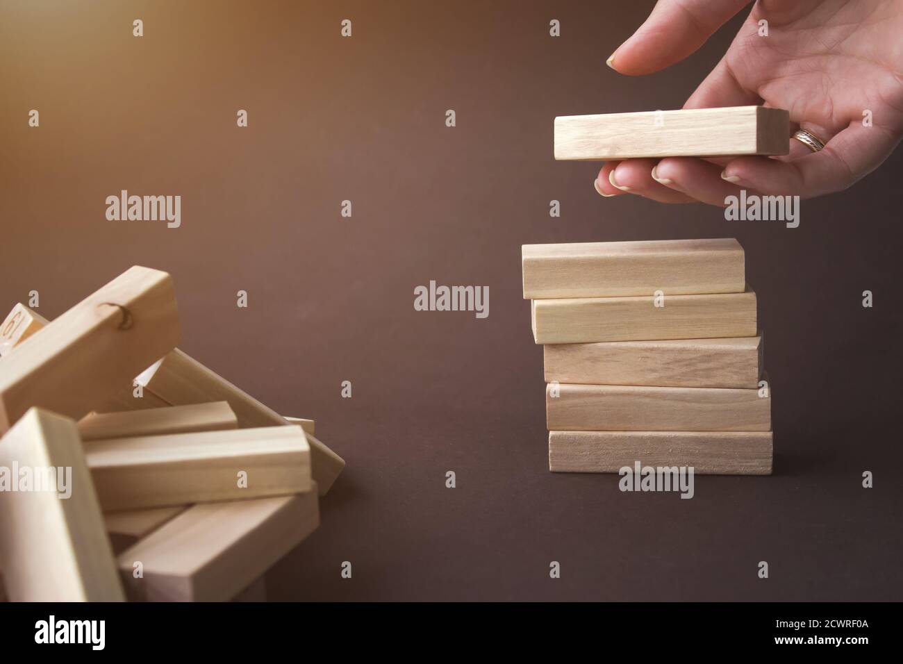 Hand arranging wood block stacking as step stair Stock Photo - Alamy