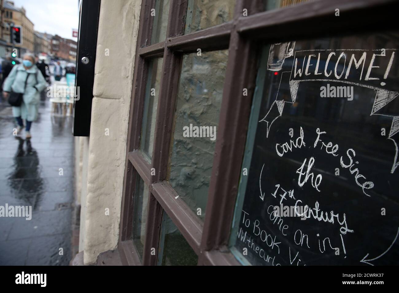 A Coronavirus related sign in a pub window in Glasgow Stock Photo - Alamy