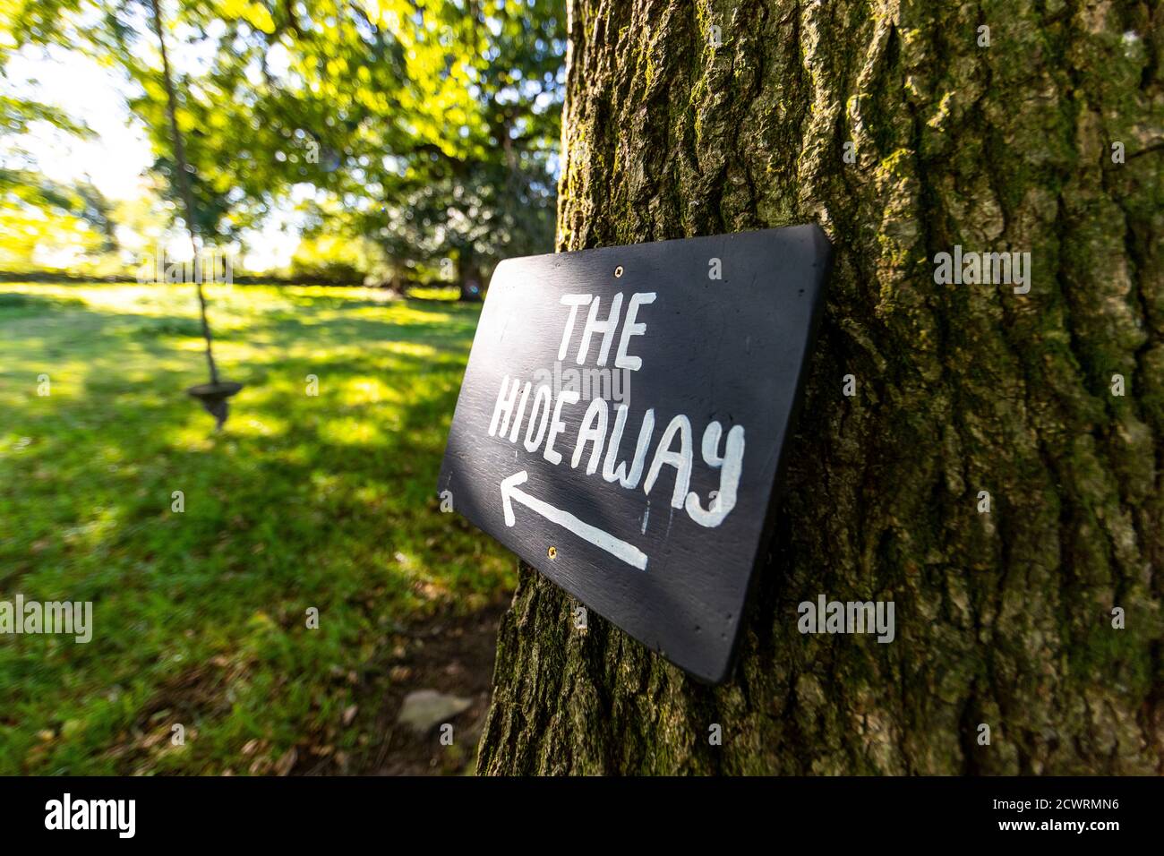 The Hideaway sign to glamping pod. Cool summer - shady Oak tree. Humble ...