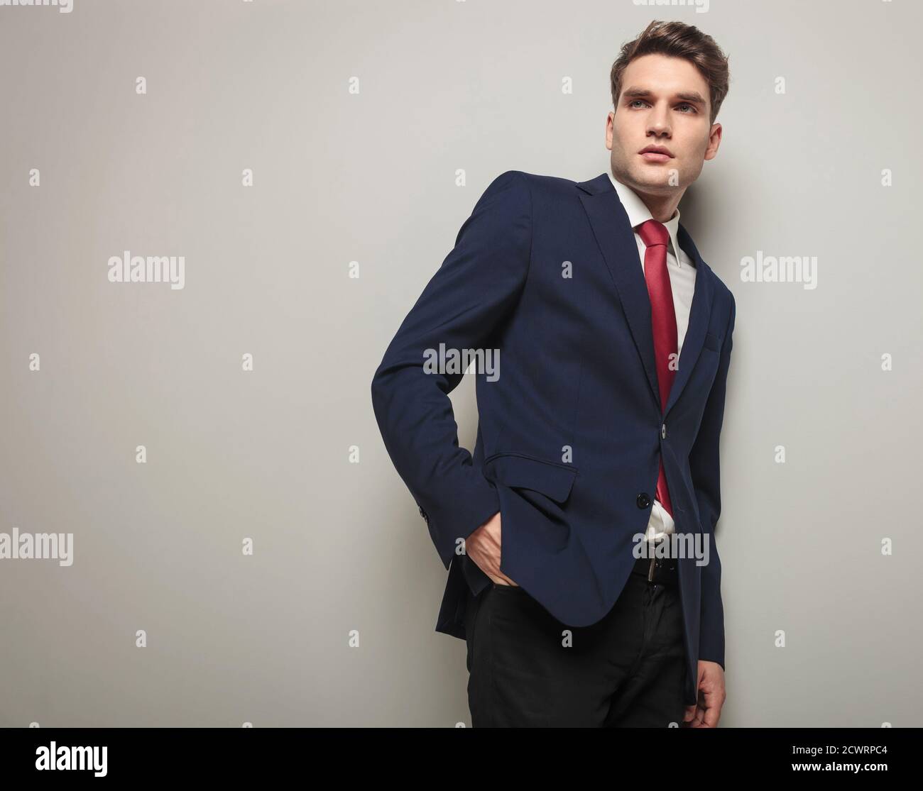 Side view of a young business man looking away from the camera while ...