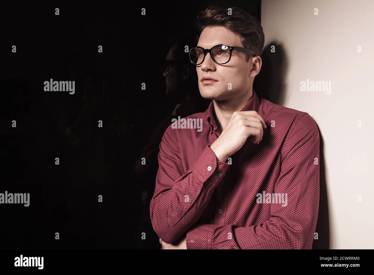 Side view of a handsome young business man looking away while thinking ... Side view of a handsome young business man looking away while thinking ...