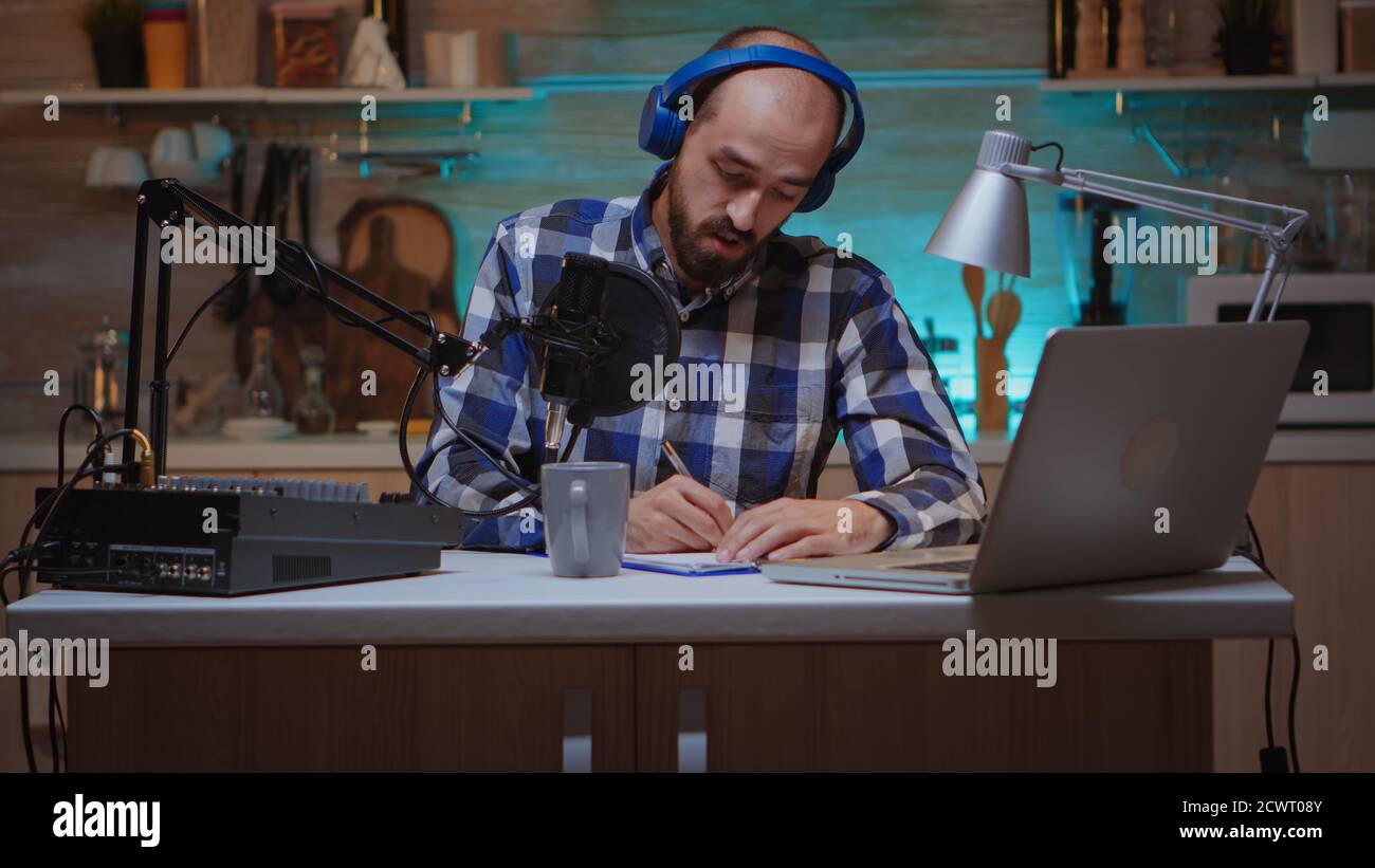 Zooming on bloger speaking on microphone telling a story during live on ...