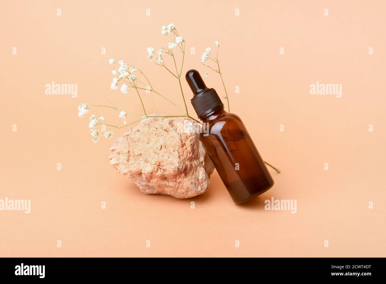 A glass bottle stands with aromatic oil on a cube Stock Photo - Alamy