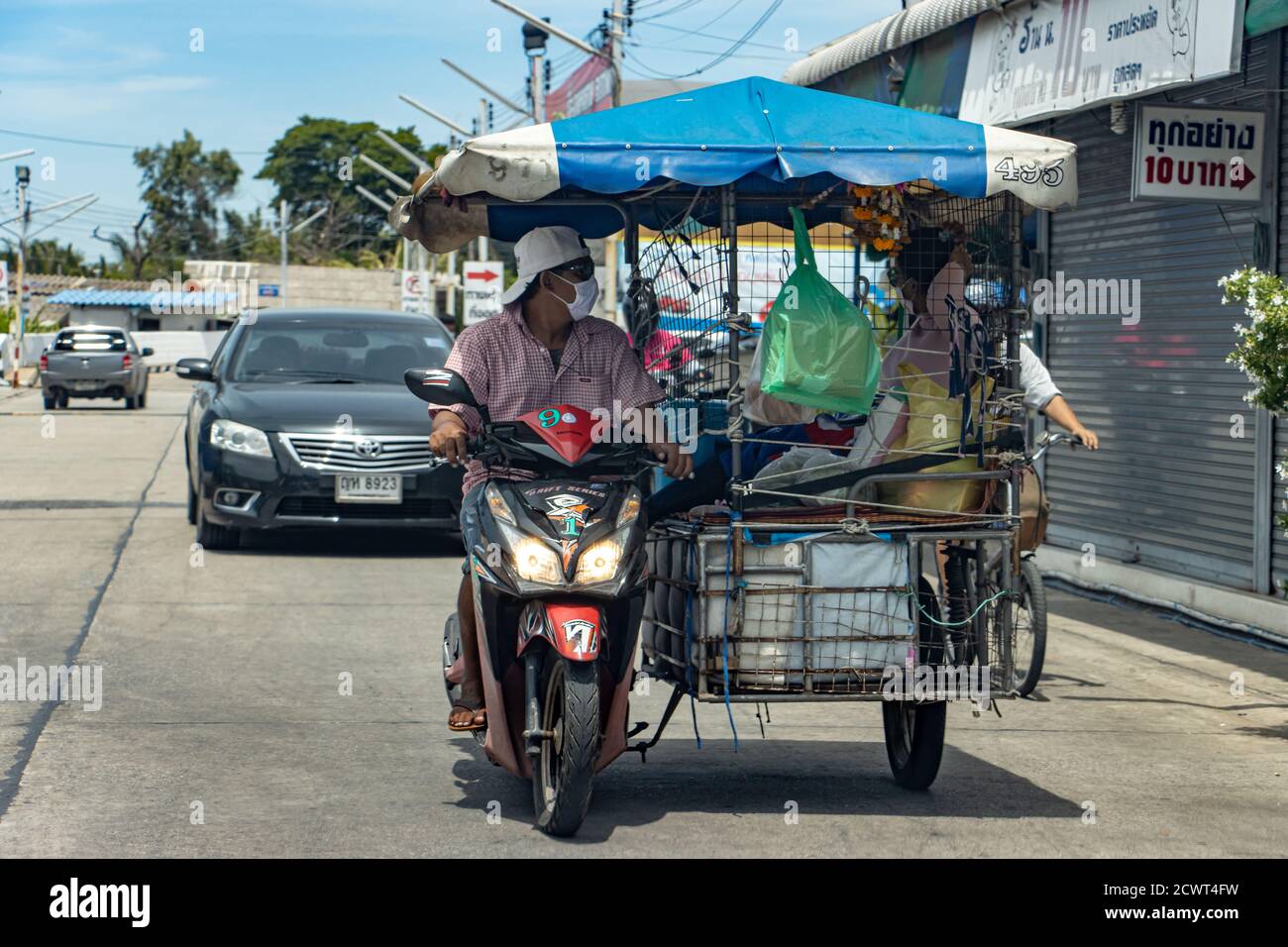 Man riding tricycle on street hi-res stock photography and images - Alamy