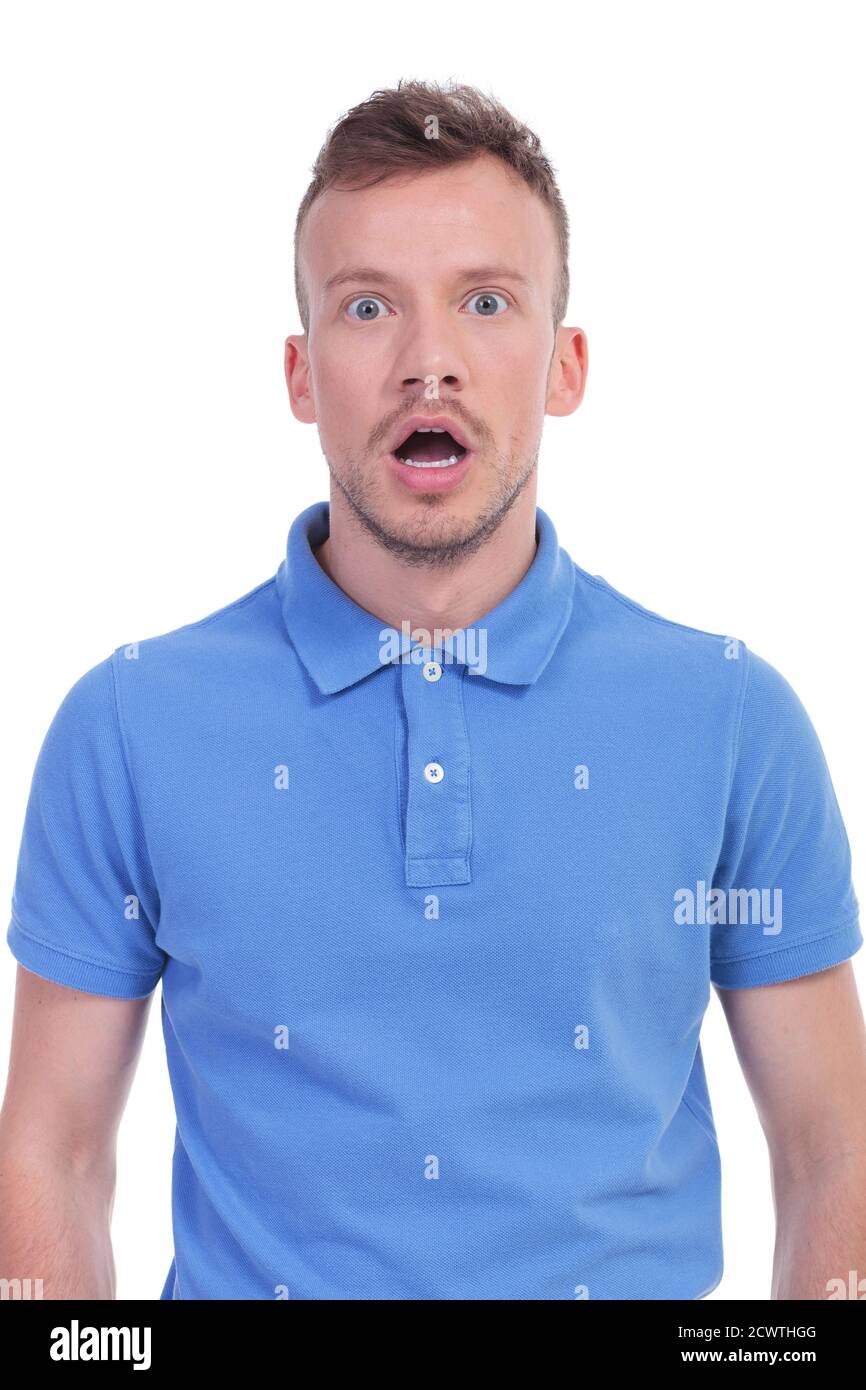 portrait of a shocked young casual man looking into the camera ...