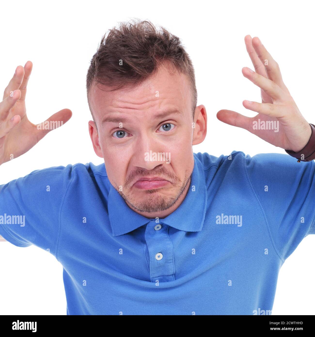 picture of a young casual man with a puzzled expression. isolated on a ...