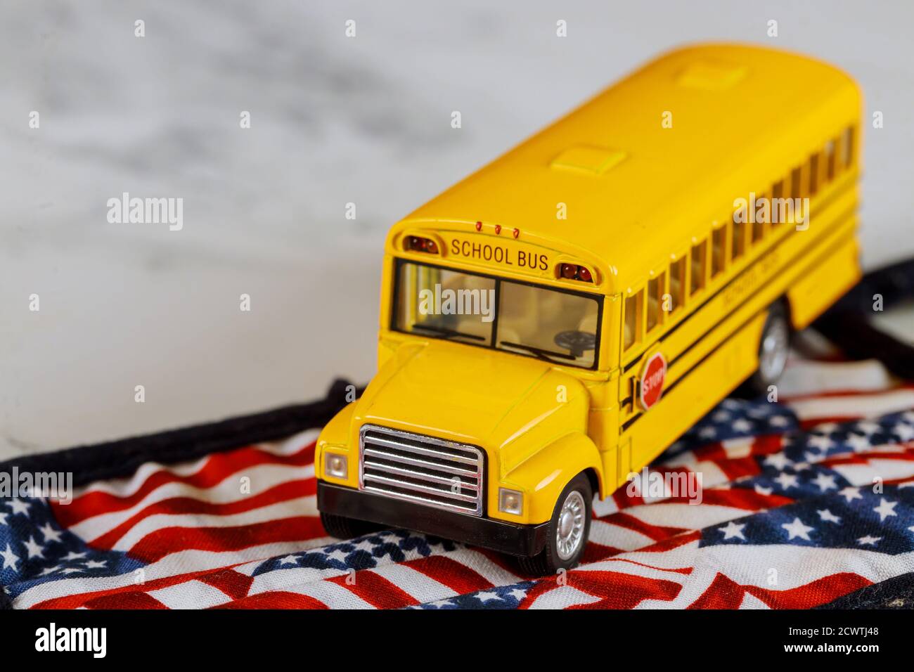 Small town school bus and american flag background Stock Photo - Alamy