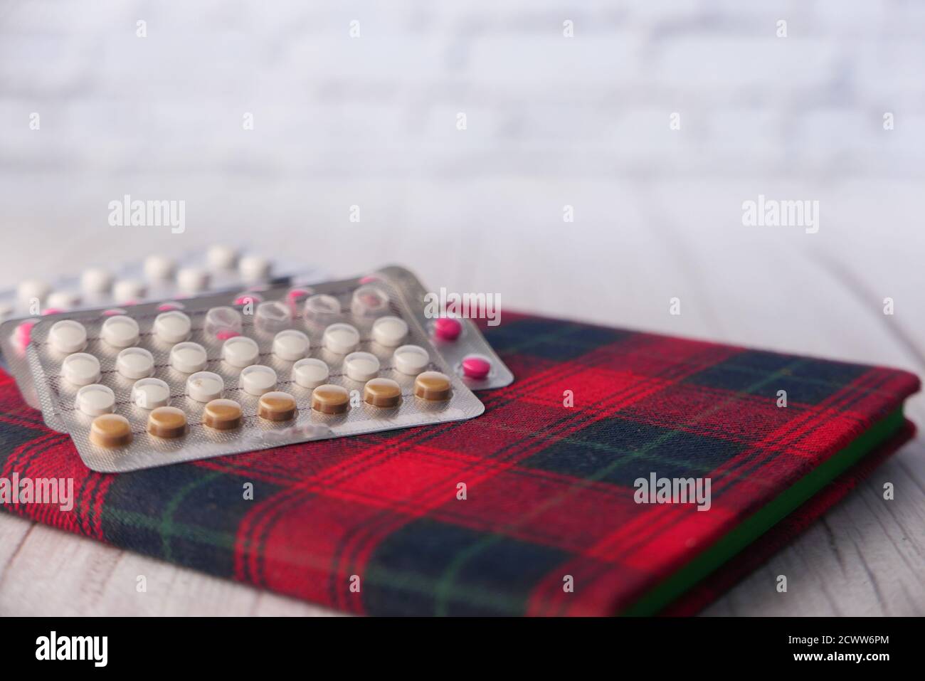 birth control pills on white background, Top view Stock Photo - Alamy
