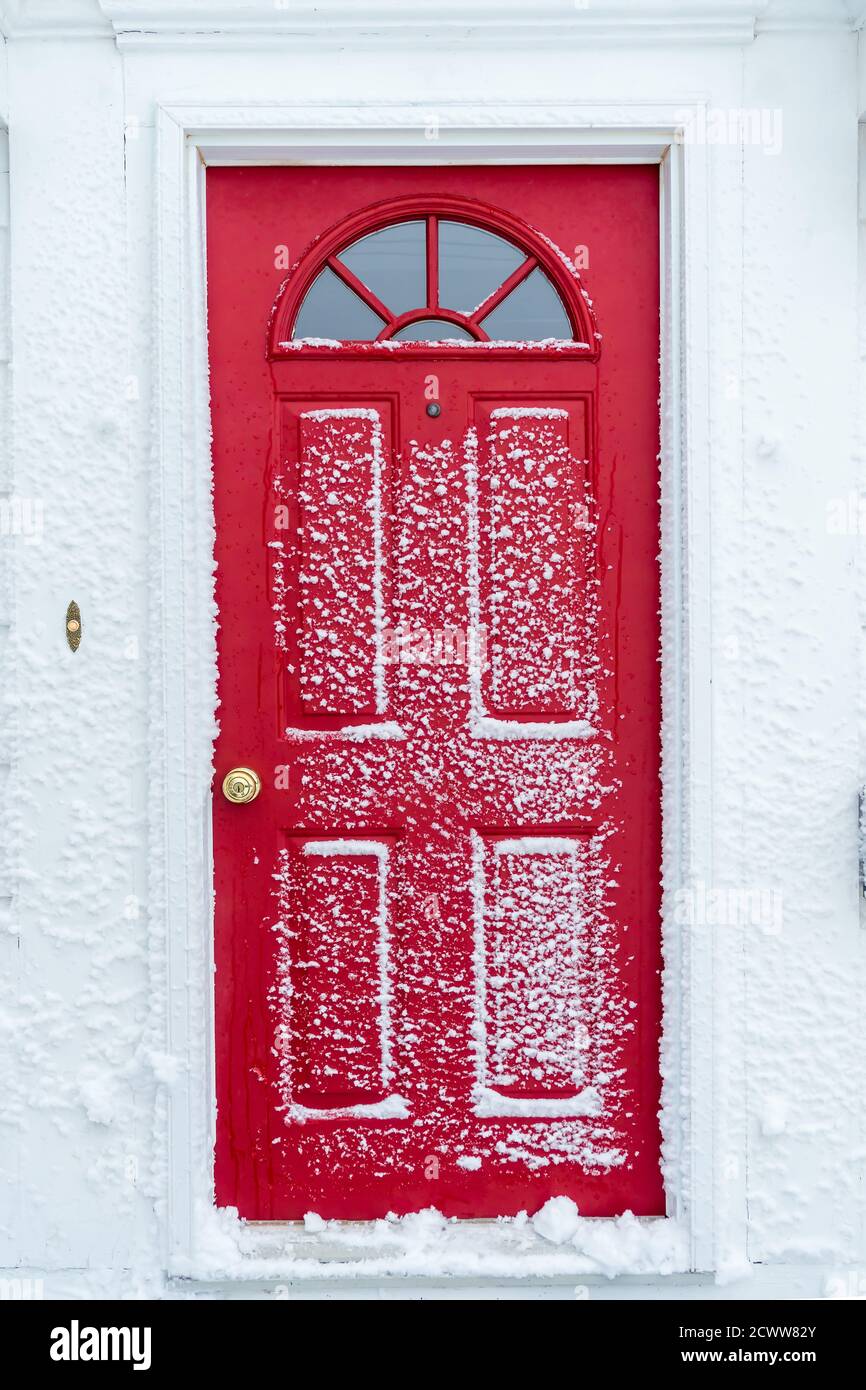 Red front door of a home covered with snow Stock Photo - Alamy