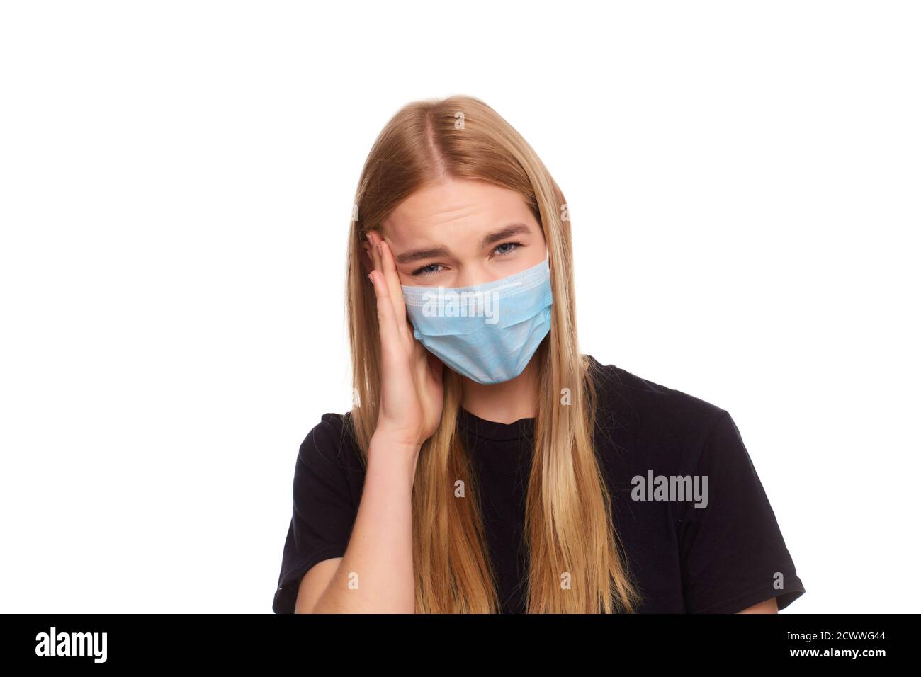 Studio portrait of young blonde illness girl with closed eyes, wearing ...