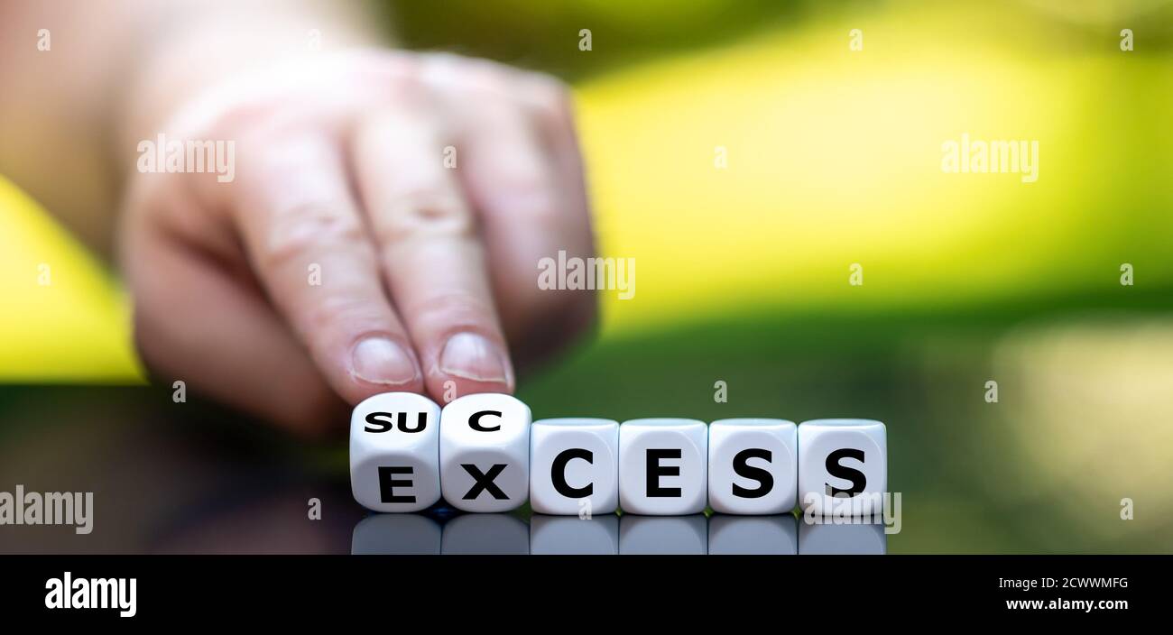 From excess to success. Hand turns dice and changes the word "excess ...